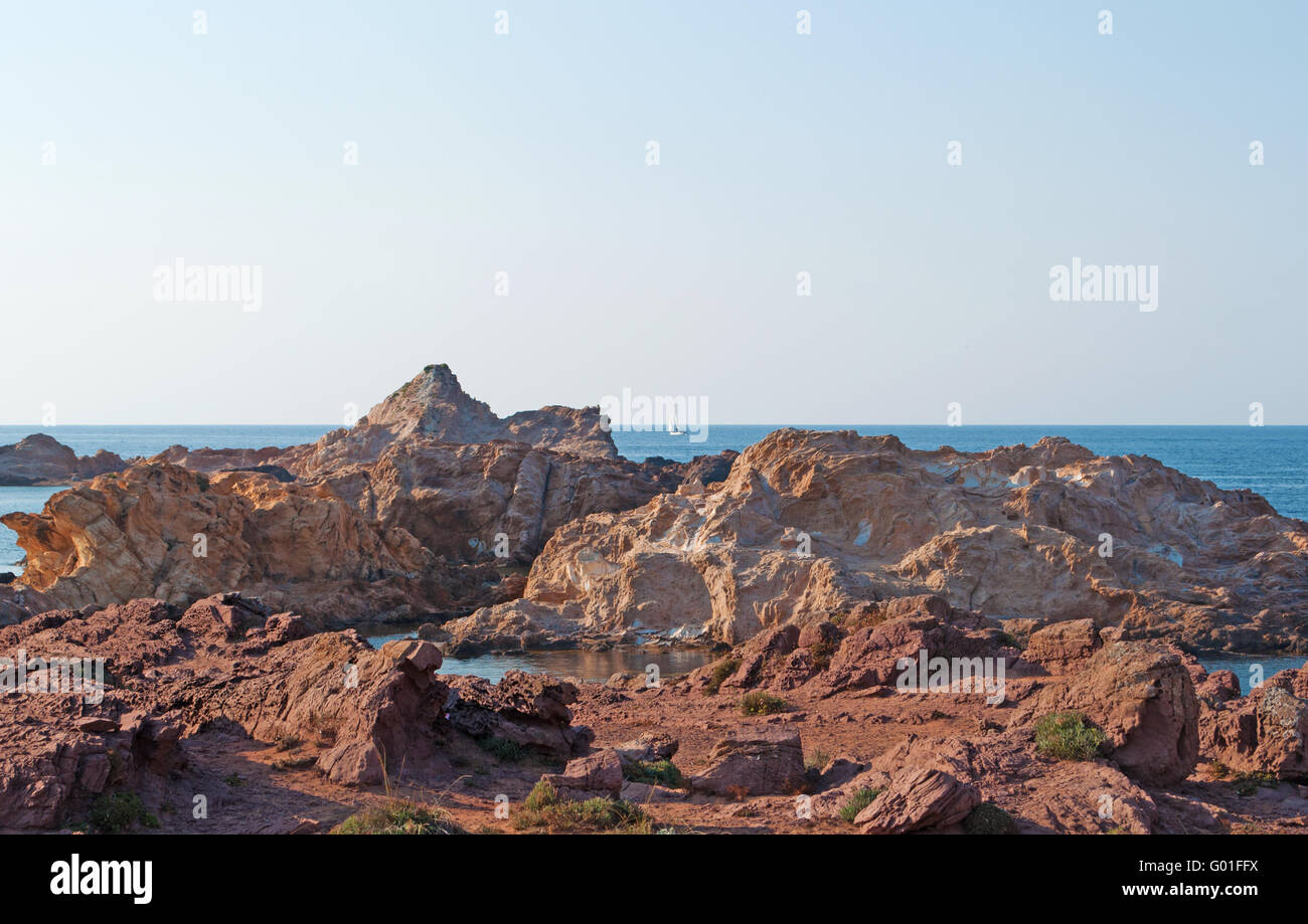 Menorca: red sand on the path to Cala Pregonda, secluded cove with ...