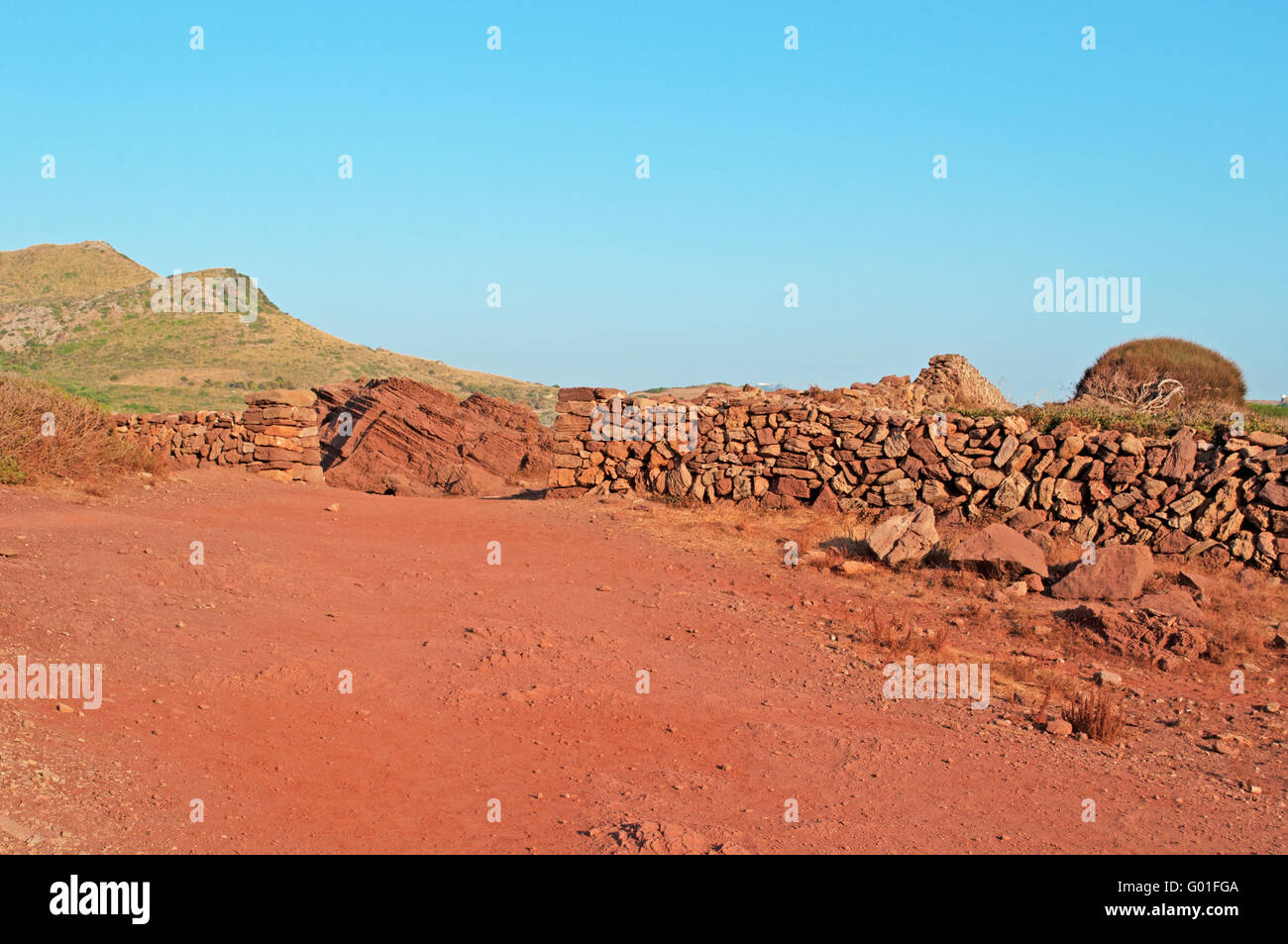 Menorca: red sand on the path to Cala Pregonda, secluded cove with ...