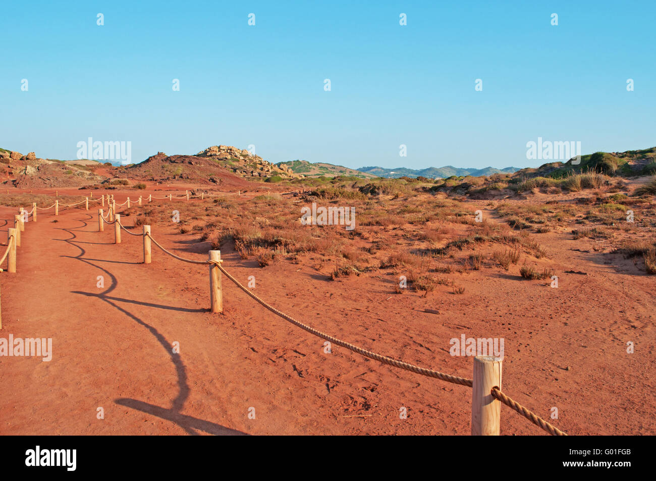 Menorca: red sand on the path to Cala Pregonda, secluded cove with ...