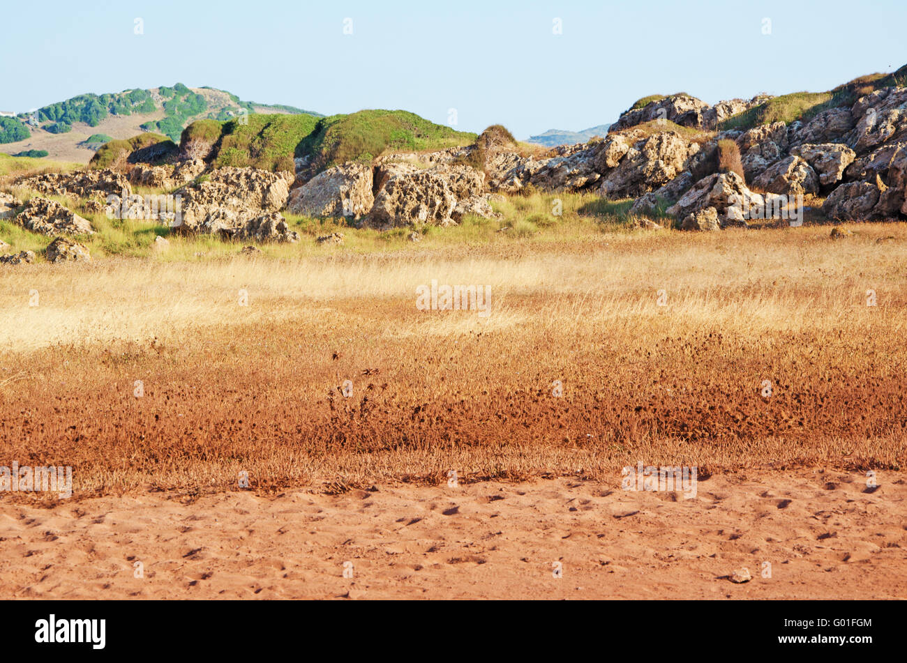 Menorca: red sand on the path to Cala Pregonda, secluded cove with ...