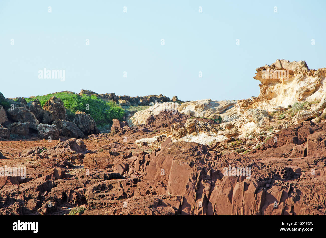 Menorca: red sand on the path to Cala Pregonda, secluded cove with ...