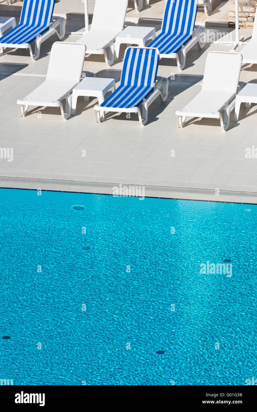 Hotel Poolside Chairs near a swimming pool. Summer shot Stock Photo - Alamy