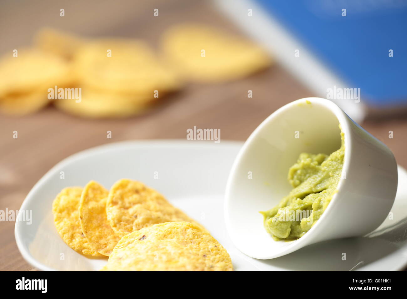 Guacamole and chips on a wooden background Stock Photo - Alamy