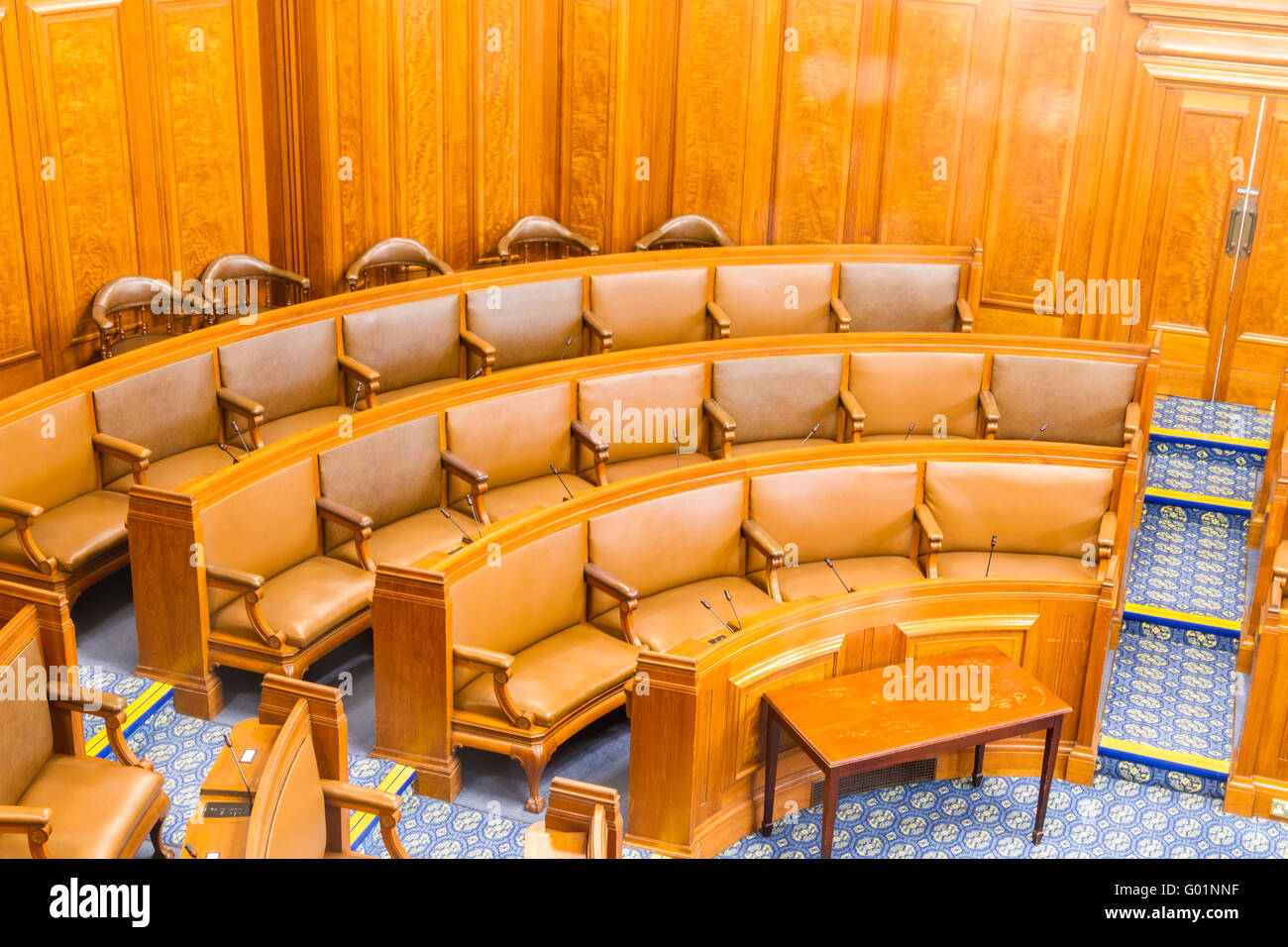 Wood and leather seats in a council chamber. Wood and leather ...
