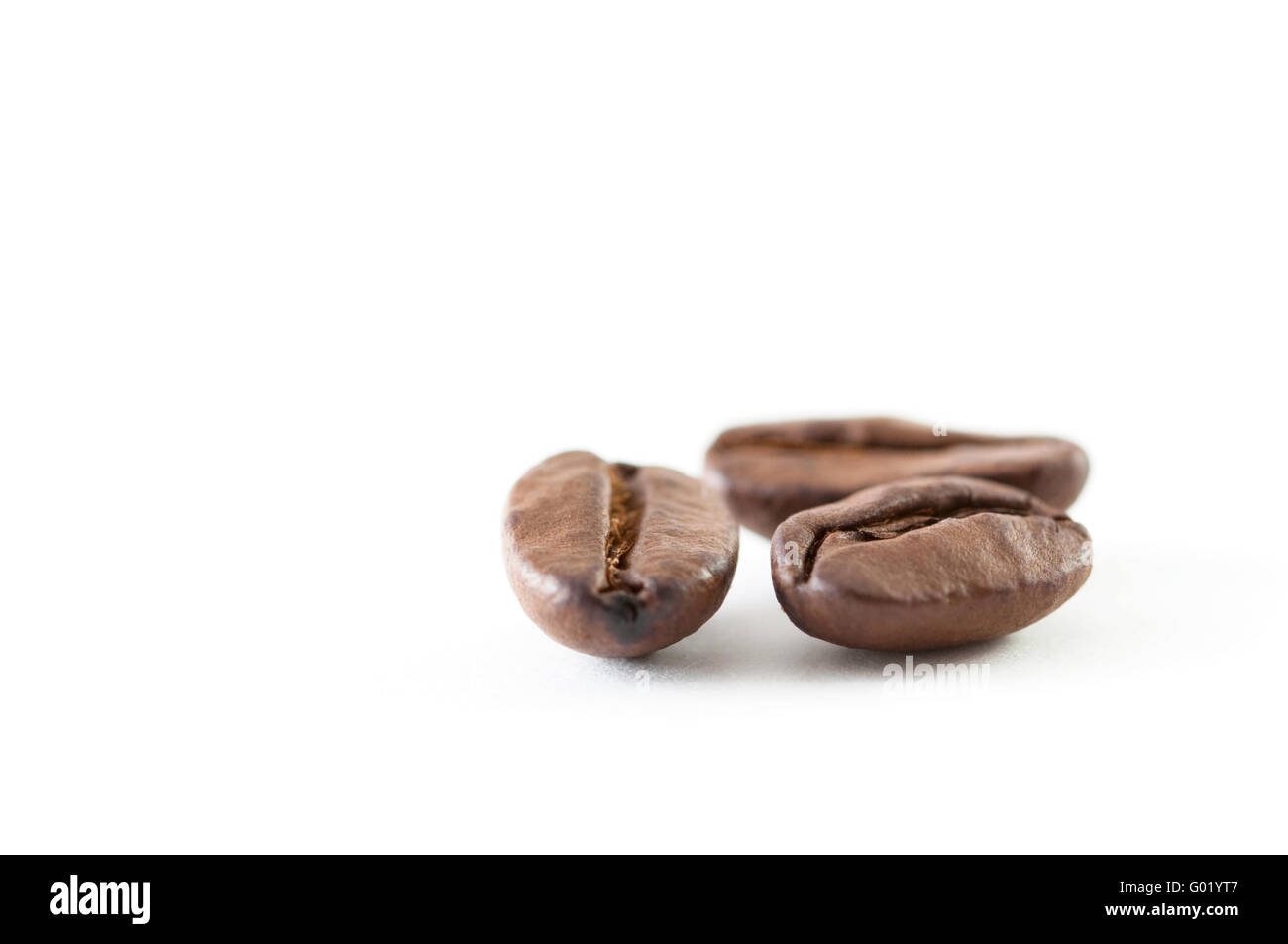 A close up shoot of some coffee beans isolated on white background ...