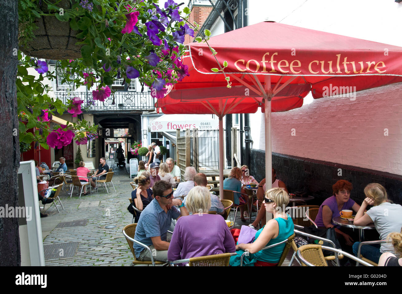GUILDFORD Alfresco dining people seated café outdoors hanging baskets ...