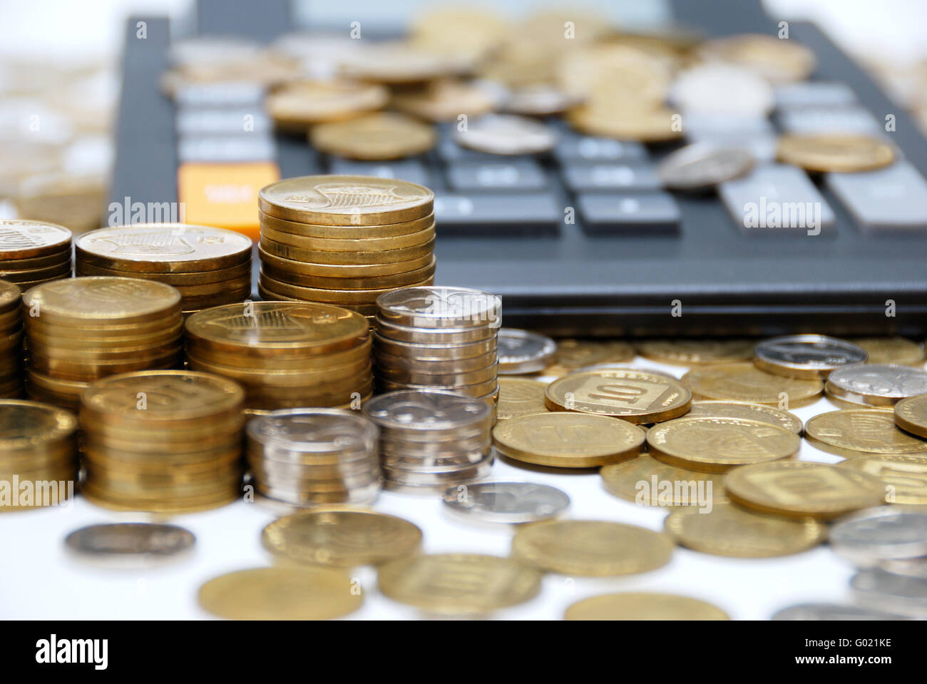 Coins & calculator Stock Photo - Alamy