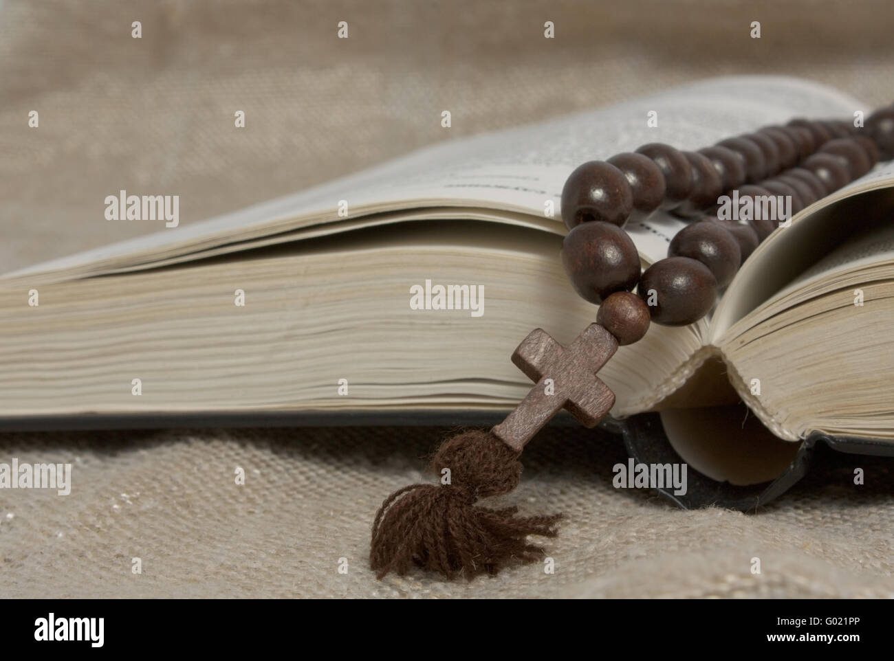black opened bible and wooden cross on rustic canvas Stock Photo - Alamy