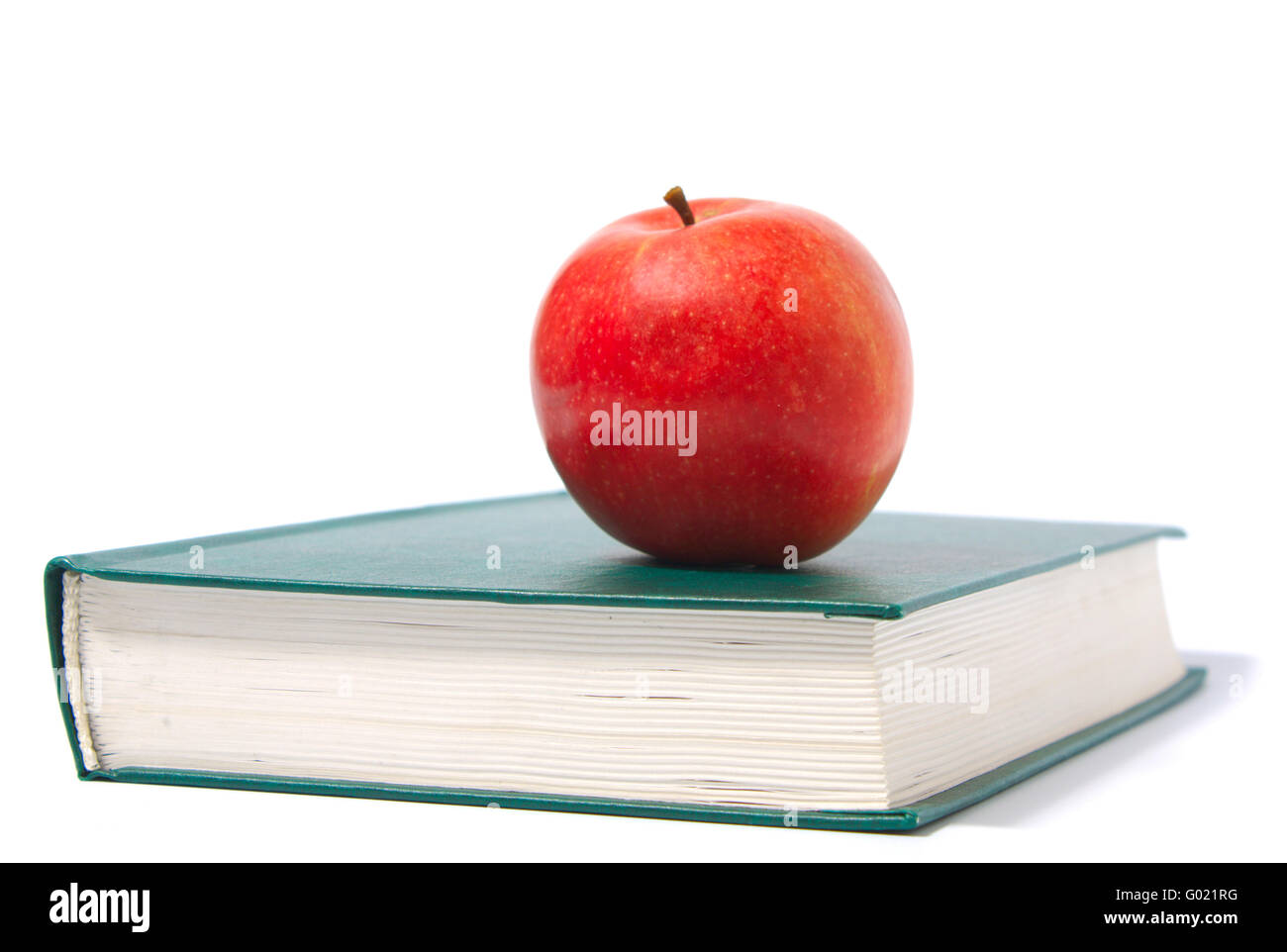 red apple and green book isolated on white background Stock Photo - Alamy