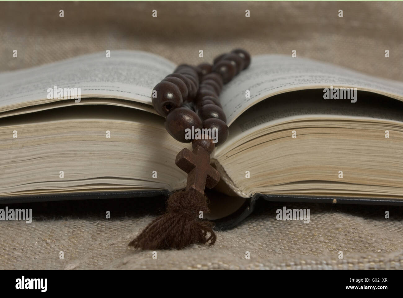 black opened bible and wooden cross on rustic canvas Stock Photo - Alamy