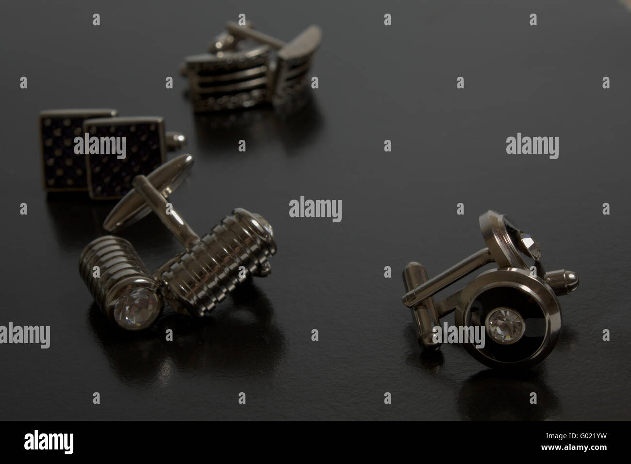 stainless steel cufflinks on the black background Stock Photo - Alamy