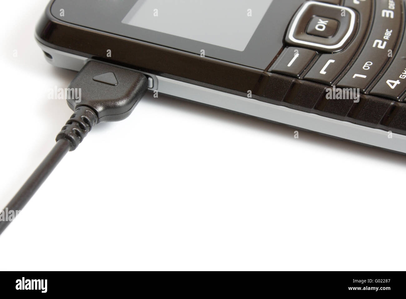 charging mobile phone isolated on white background Stock Photo - Alamy