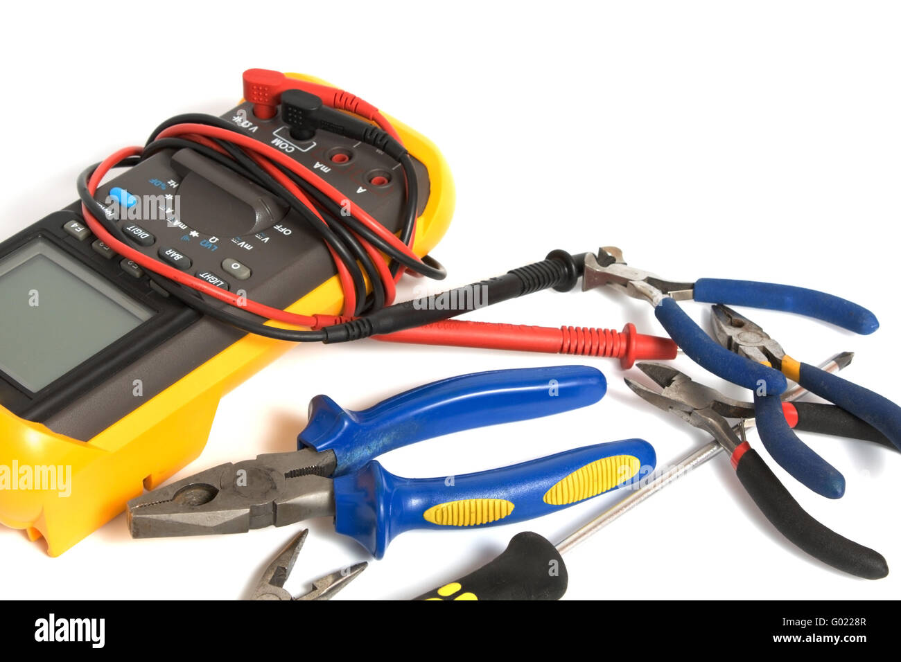 Professional digital multimeter and tools isolated on the white ...