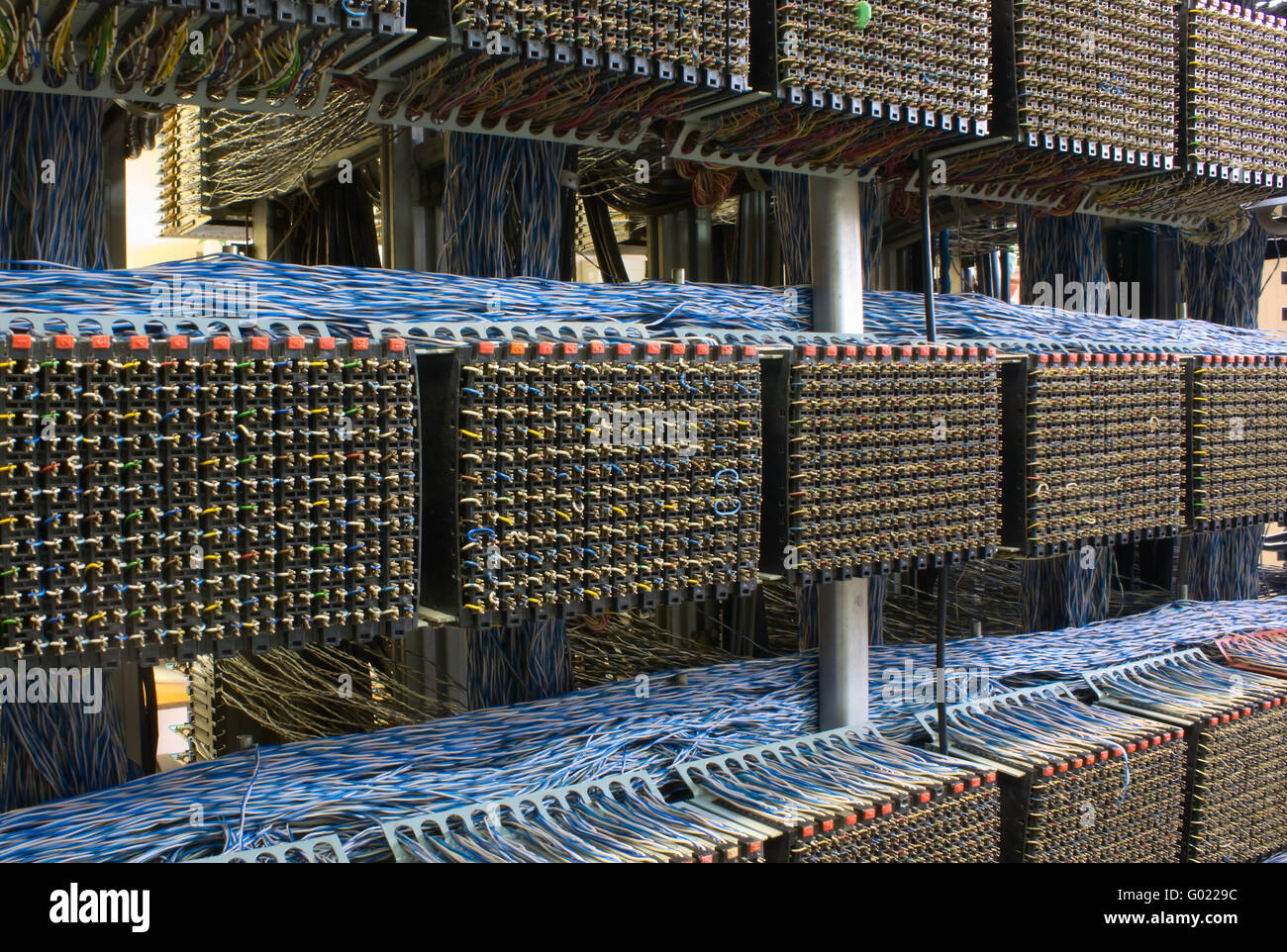 old telephone switchboard with wires of white and dark blue colors ...