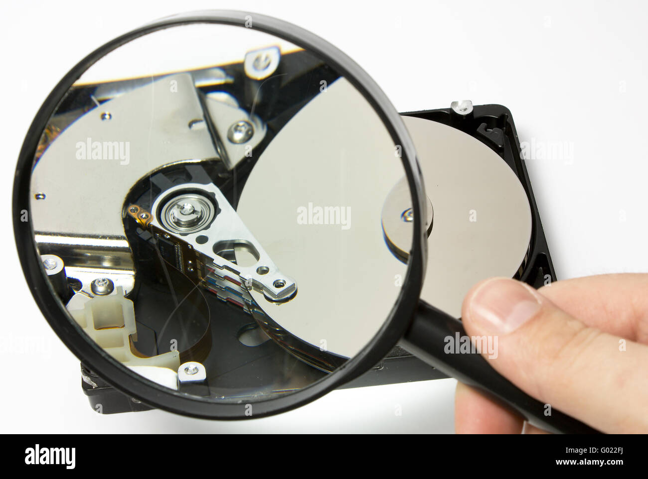 open Hard Drive with magnifying glass on white Stock Photo - Alamy