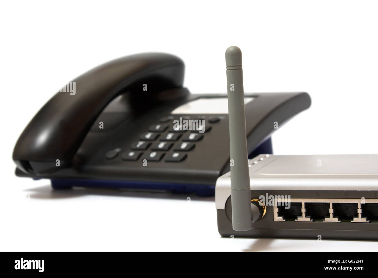 Black office phone and gray wi-fi router on white Stock Photo - Alamy