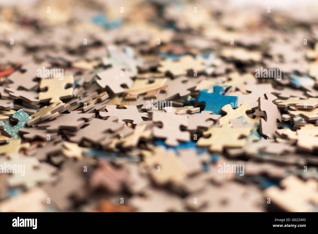 the background unsolved bunch of jigsaw puzzles pieces Stock Photo - Alamy