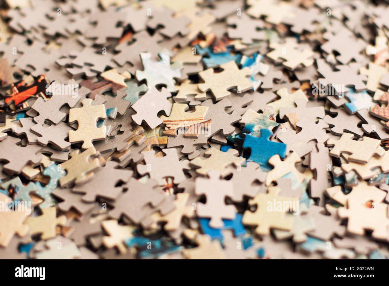 the background unsolved bunch of jigsaw puzzles pieces Stock Photo - Alamy