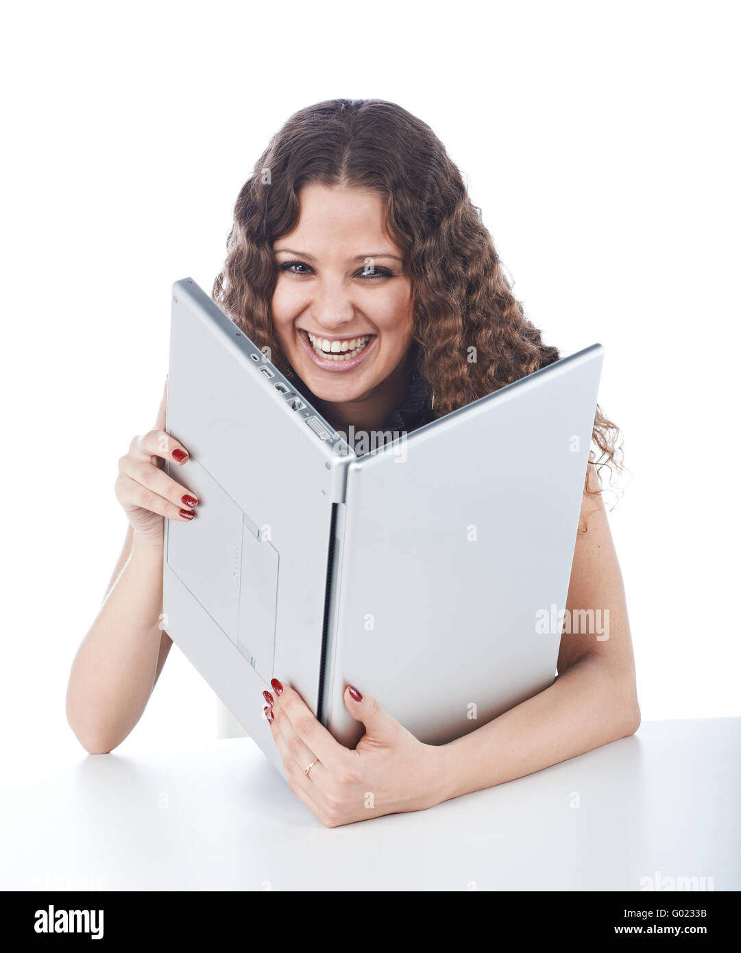 Beautiful young woman holding a laptop in improper way isolated on ...