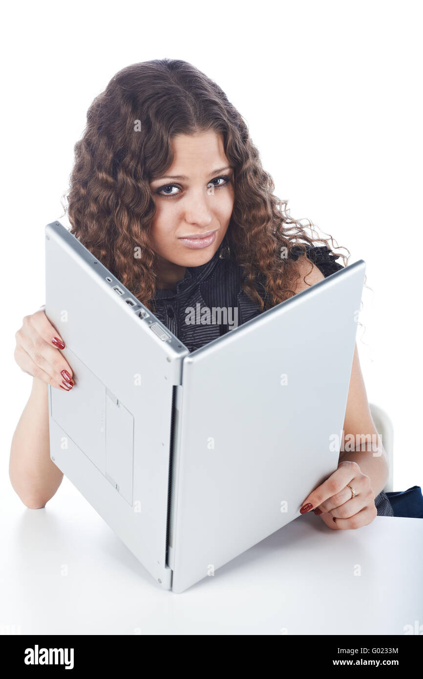 Beautiful young woman holding a laptop in improper way isolated on ...