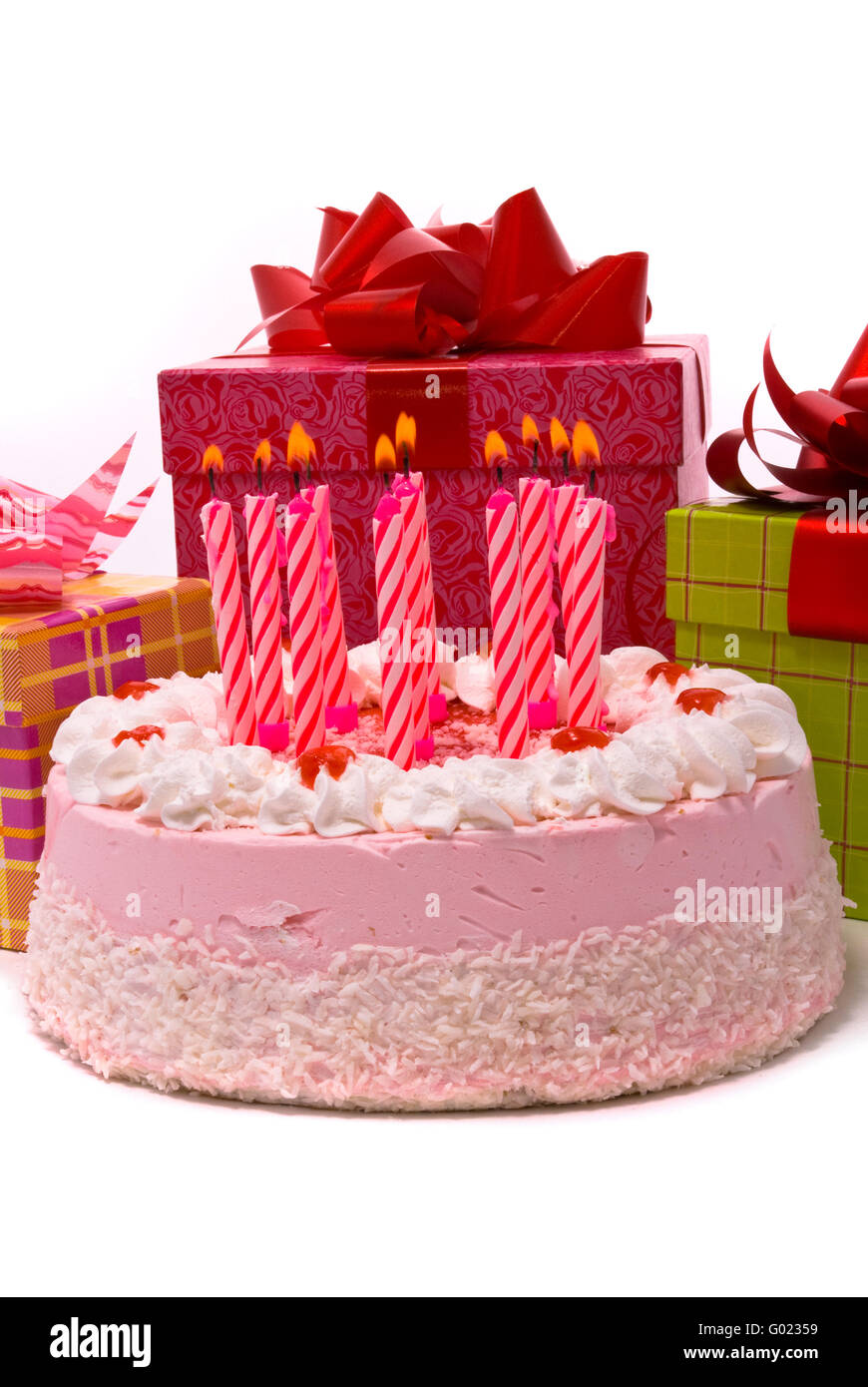 Pink pie with eleven candles and gifts in boxes on a white background ...