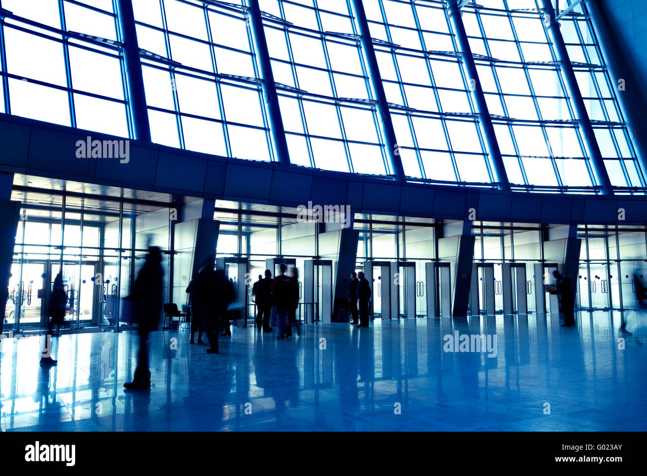 People in wide blue enter hall window in exposition center Stock Photo ...