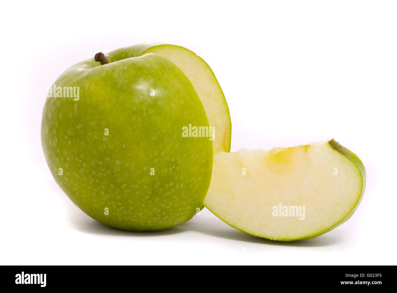 Sliced green ripe apple isolated on white background Stock Photo - Alamy