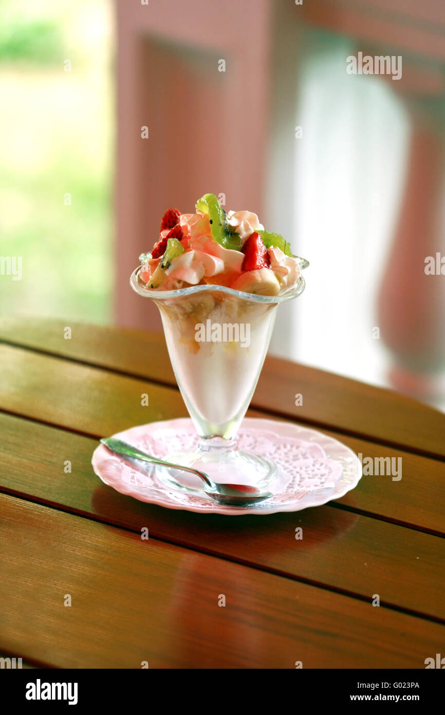 beautiful ice-cream in glass with fruits and chocolate Stock Photo - Alamy