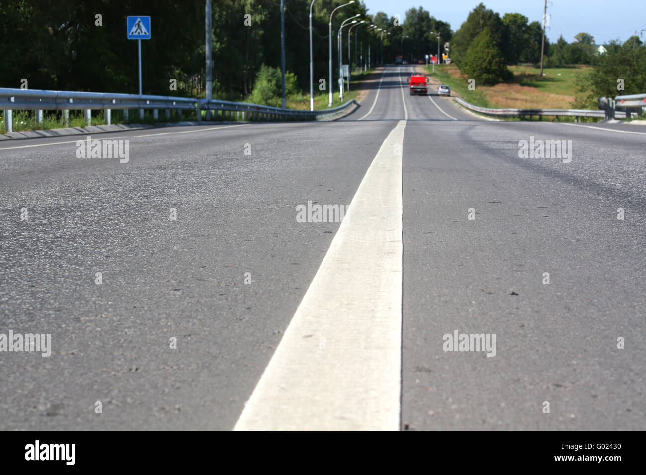 Red tow truck traveling on the road. Traffic signs Stock Photo - Alamy