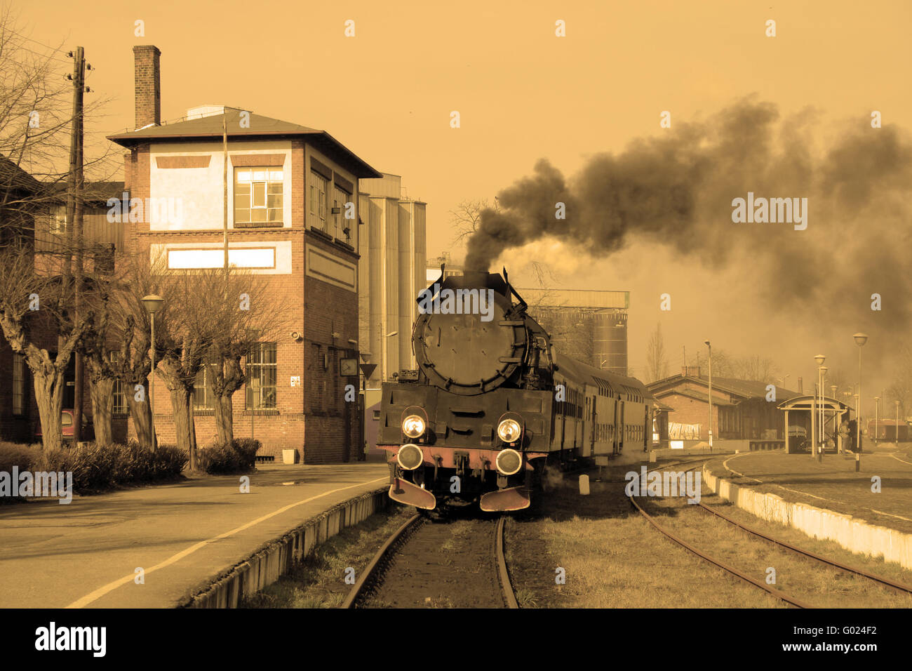Old retro steam train stopped at the small station Stock Photo - Alamy