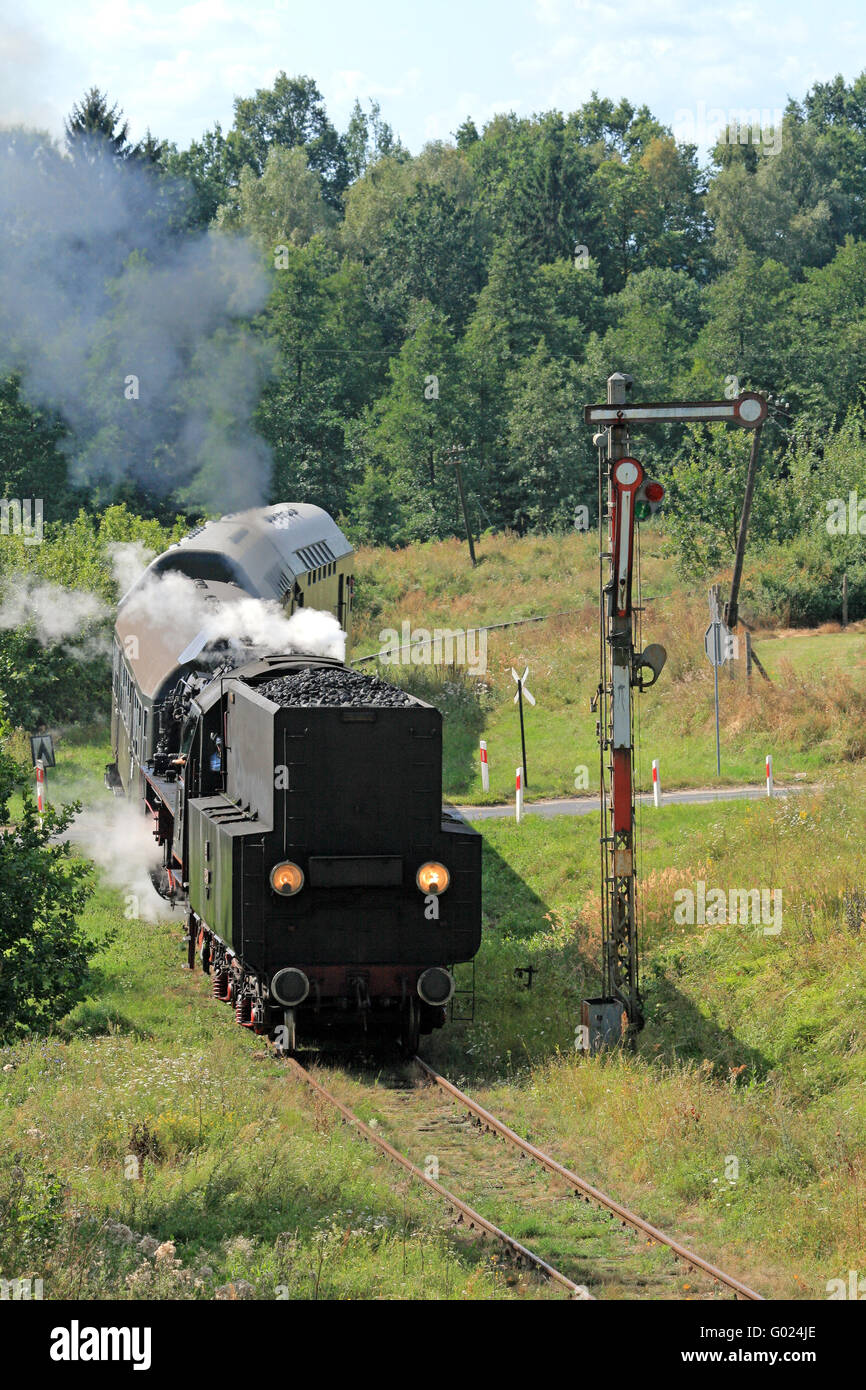 Old retro steam train passing through polish countryside Stock Photo ...