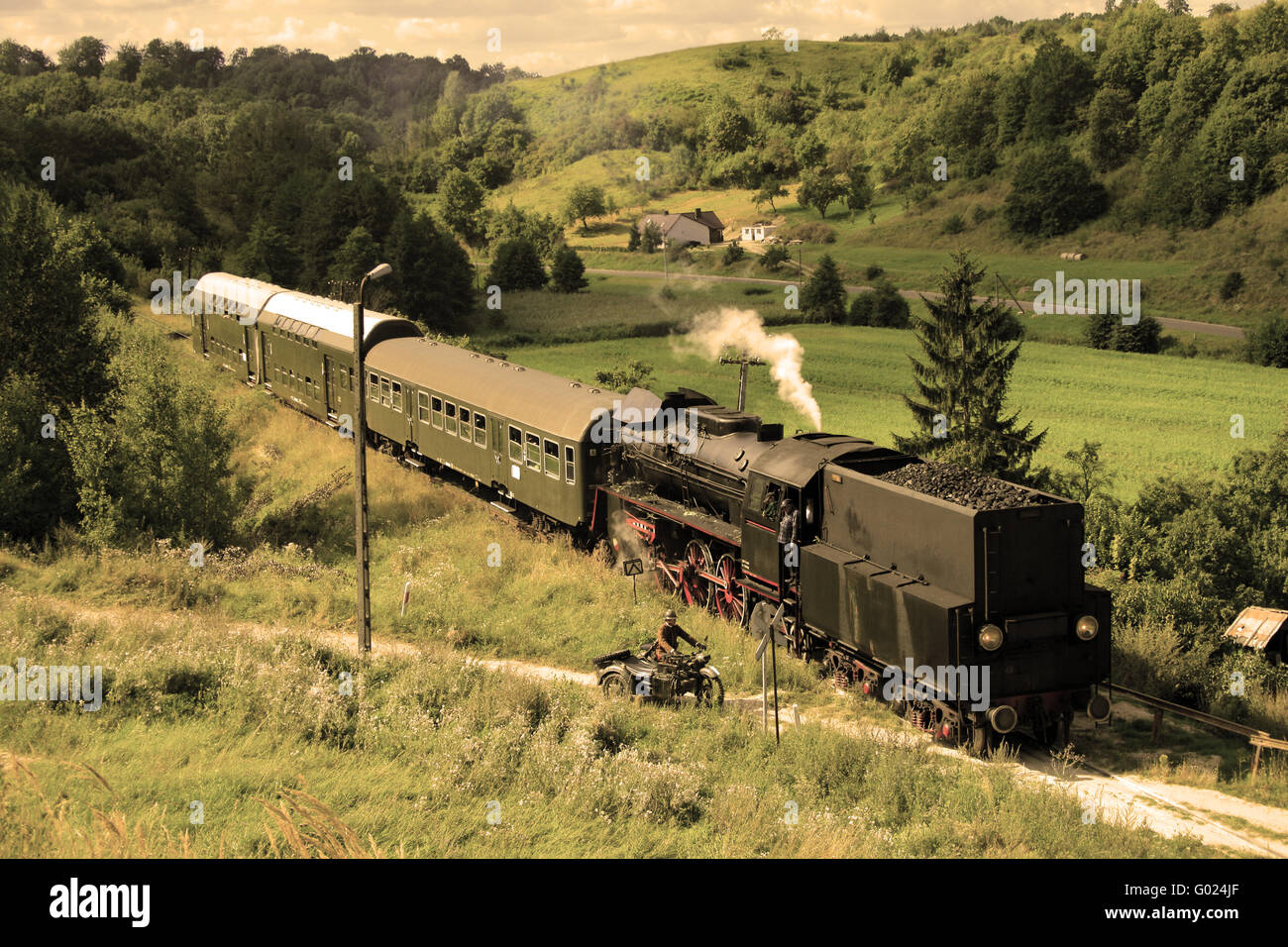 Beautiful hilly landscape with an old retro steam train Stock Photo - Alamy