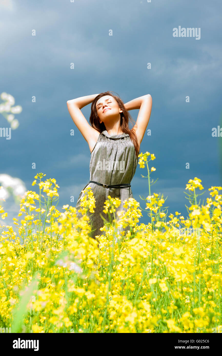 Young happy girl in yellow flowers Stock Photo - Alamy