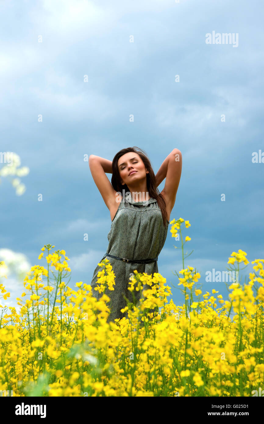 Young happy girl in yellow flowers Stock Photo - Alamy