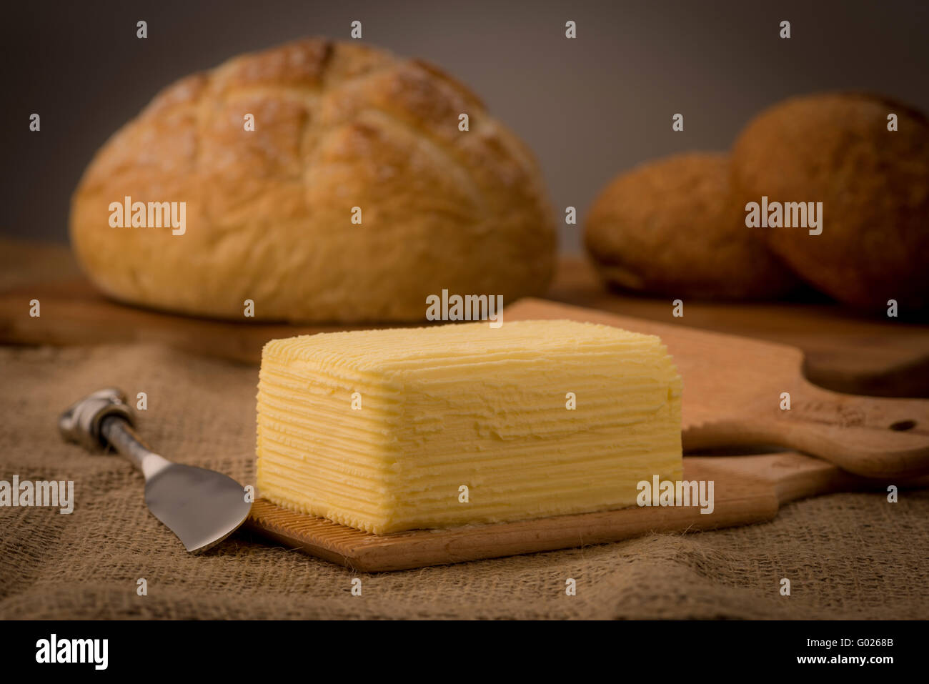 Hand churned homemade butter on wooden paddles with butter knife and ...