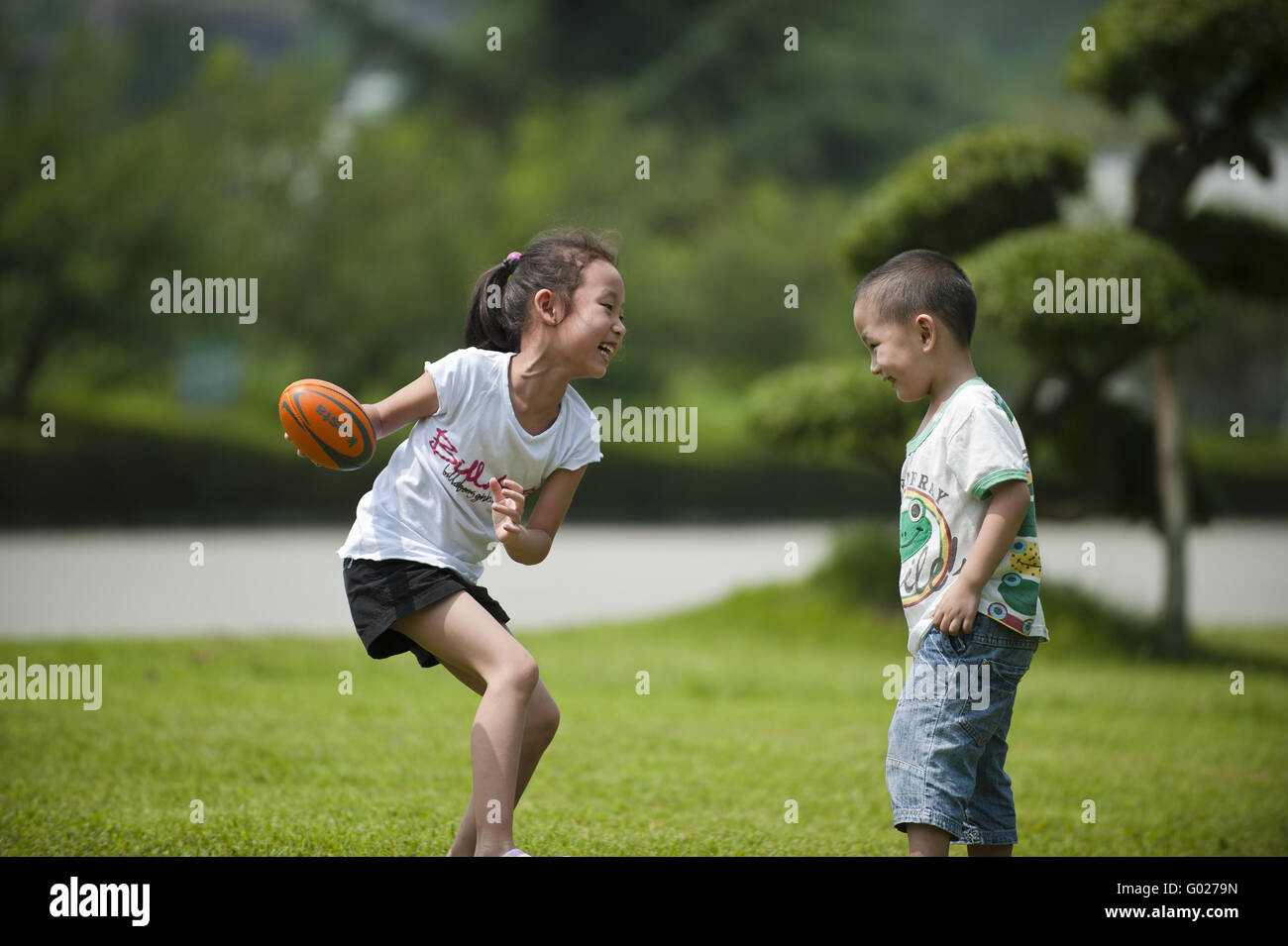 boy and girl play ball Stock Photo - Alamy