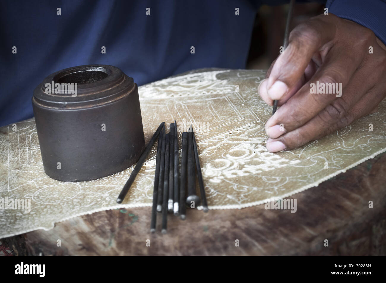 Traditional craftsman carving wood making indonesian puppets Stock ...