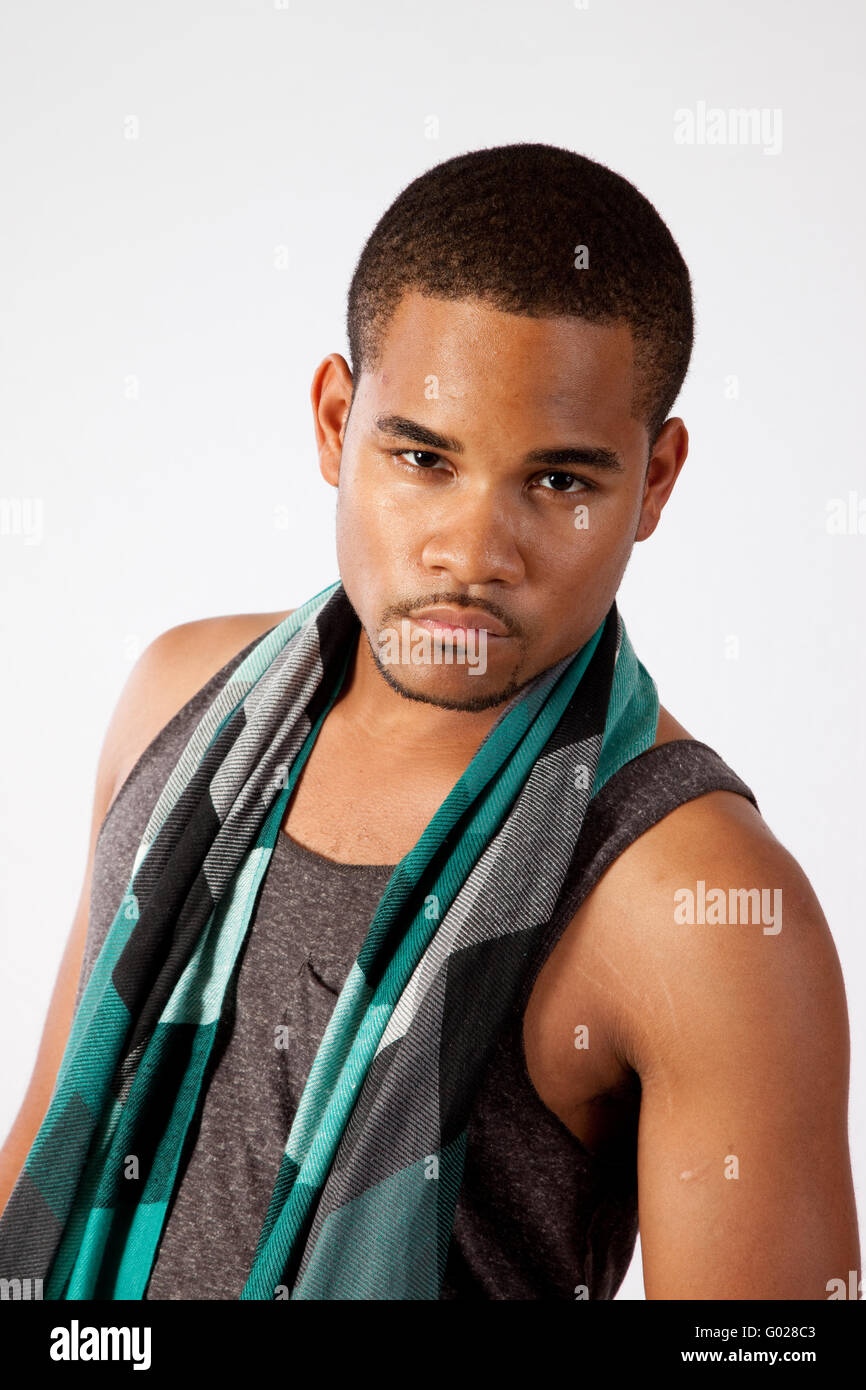 Young man with a scarf around his neck, looking thoughtfully at the ...