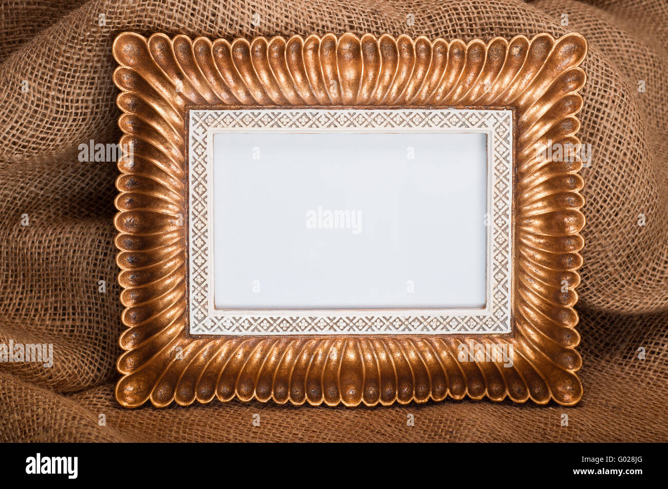 Beautiful ornate golden picture frame on hessian background Stock Photo ...