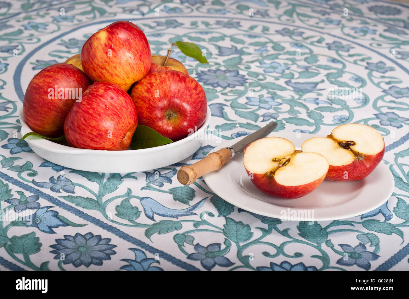Fresh red apples on a table covered with blue and green cloth Stock ...