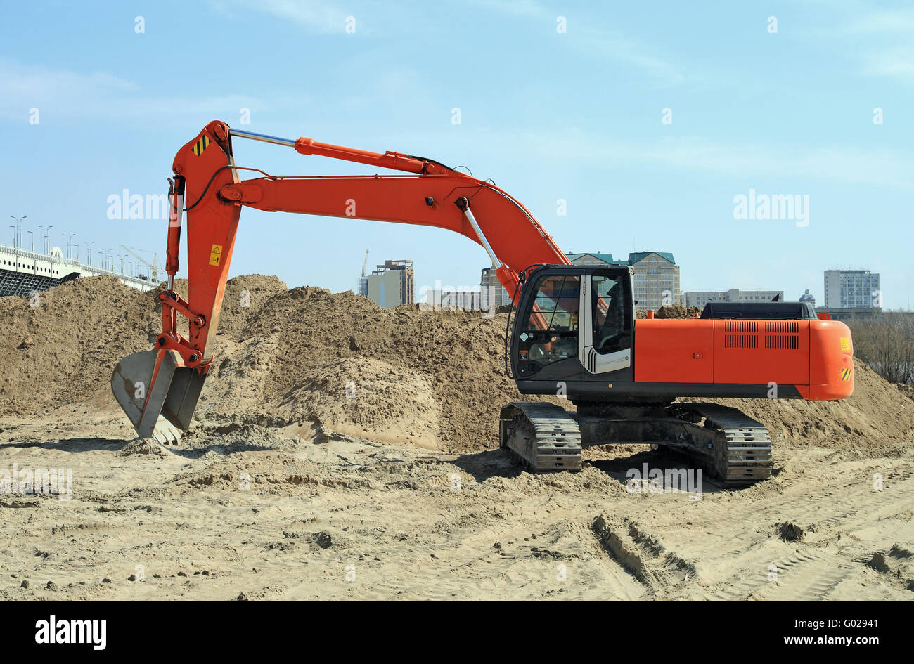 Modern dredge on a background of a cityscape Stock Photo - Alamy