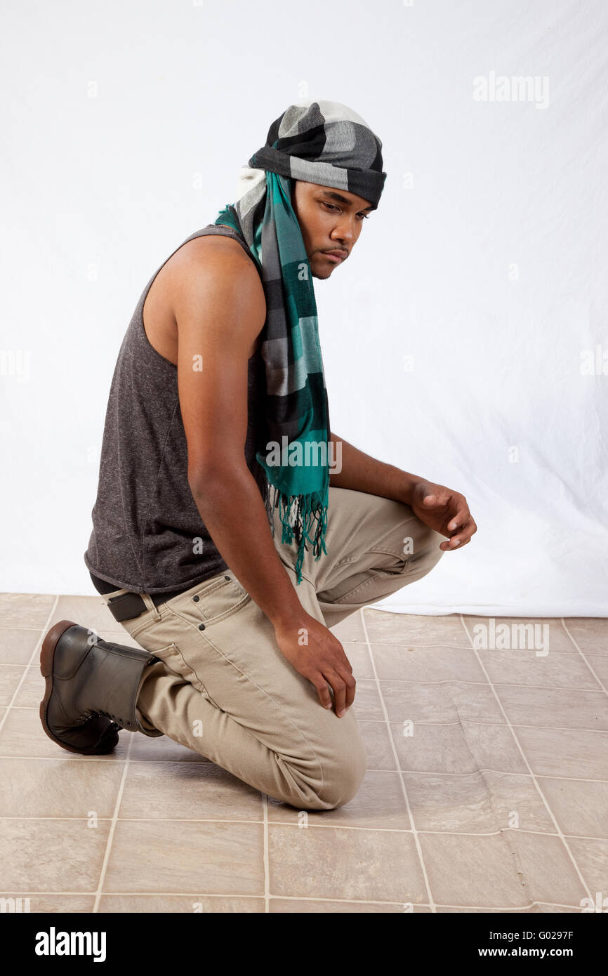 Young black man wearing a head scarf and looking serious Stock Photo ...