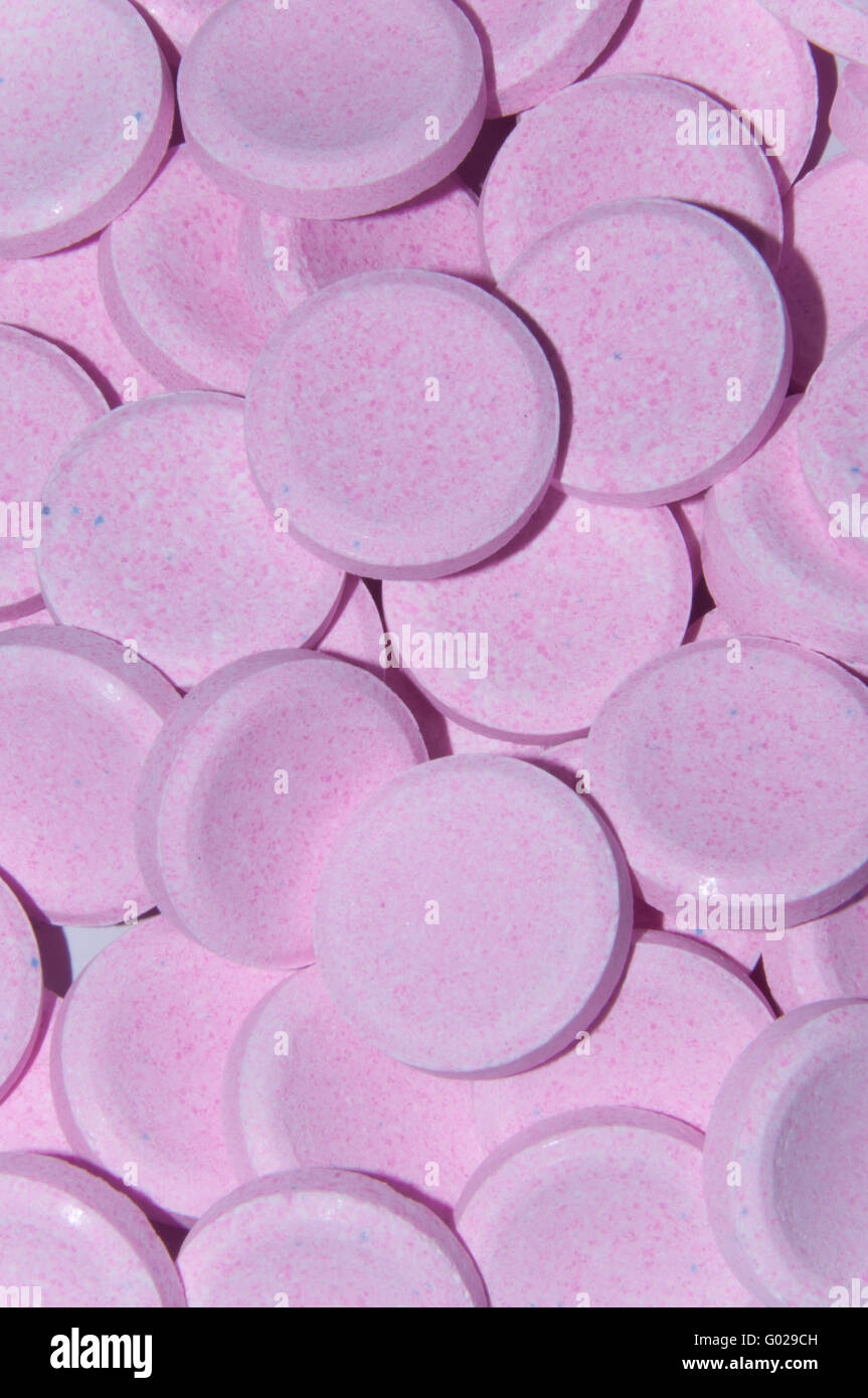effervescent pink pills isolated and disordered Stock Photo - Alamy