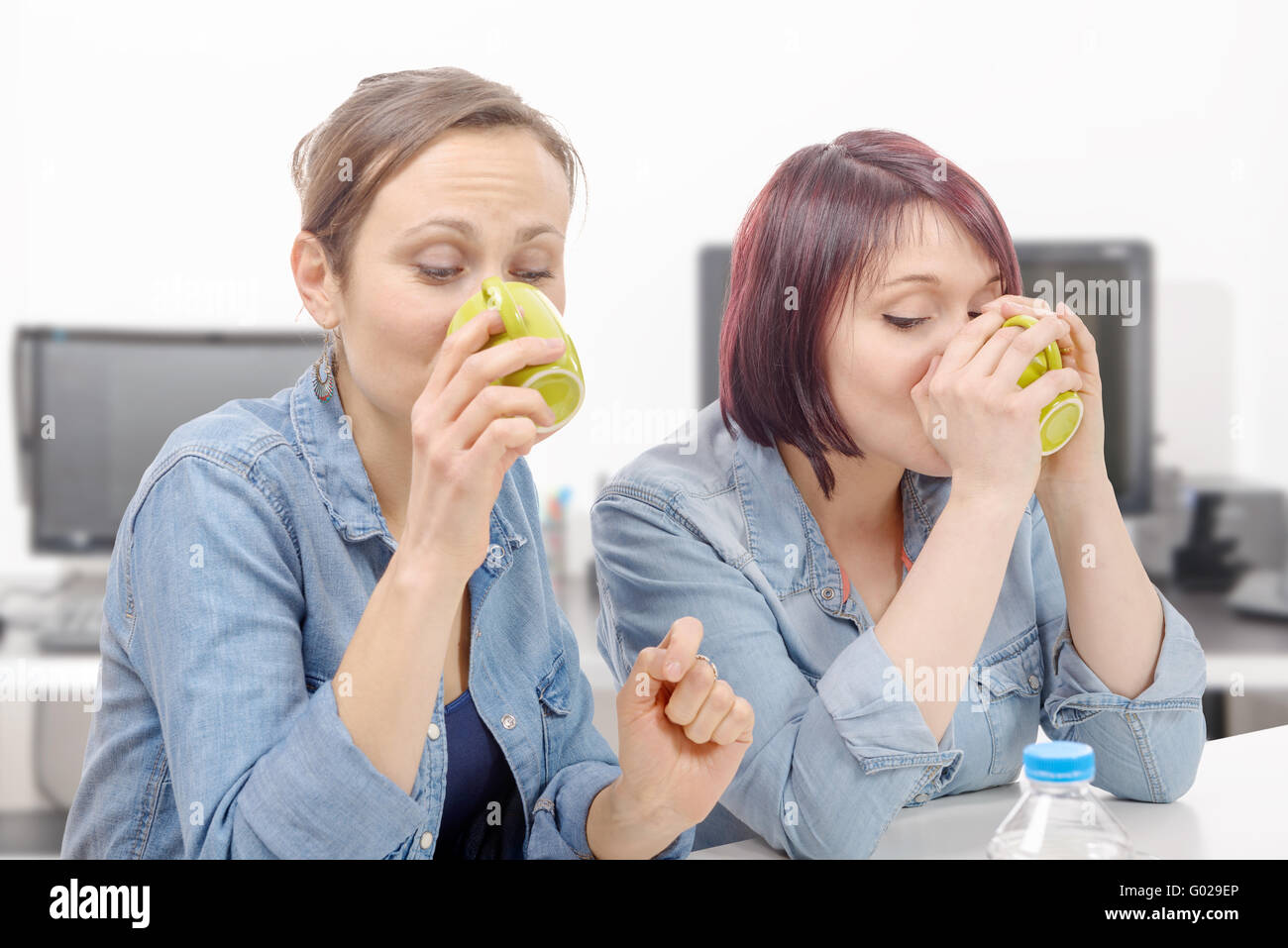 Attractive two female colleagues are making a coffee break Stock Photo ...