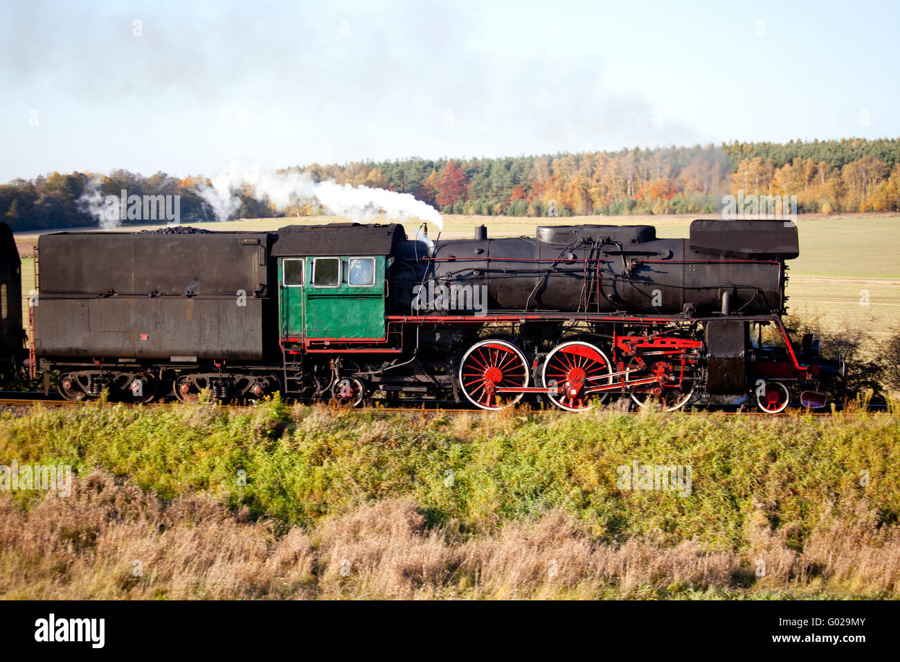 Old retro steam train passing through polish countryside Stock Photo ...