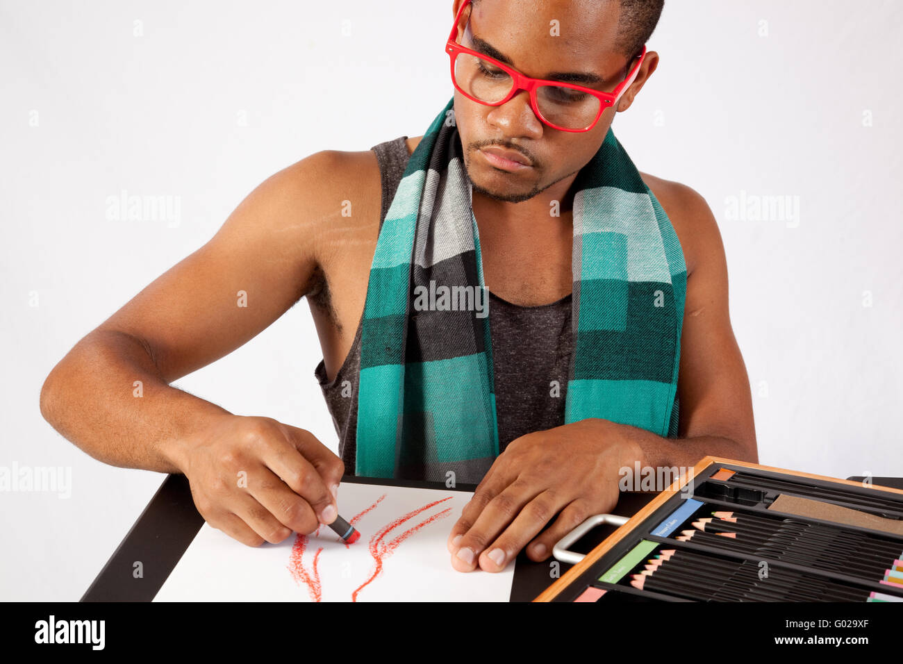 Handsome black man drawing on paper with pastel Stock Photo - Alamy
