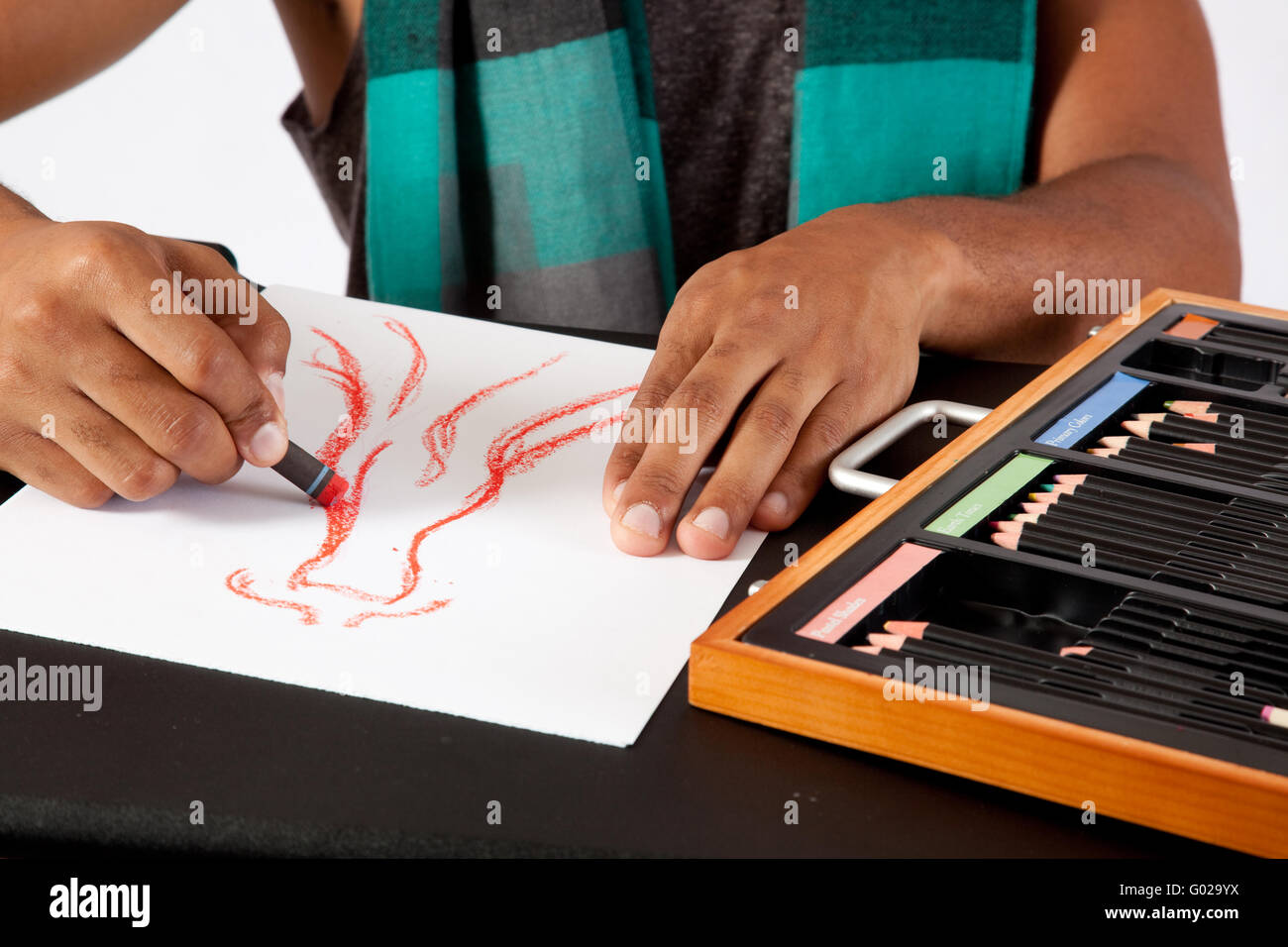 Handsome black man drawing on paper with pastel Stock Photo - Alamy