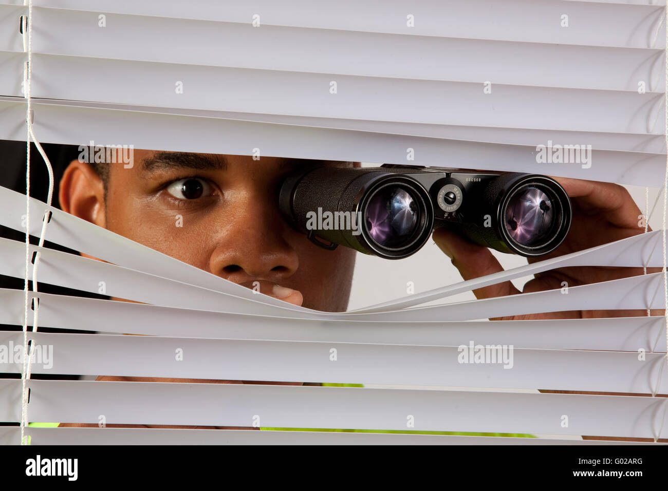 Man peeking though blinds hi-res stock photography and images - Alamy