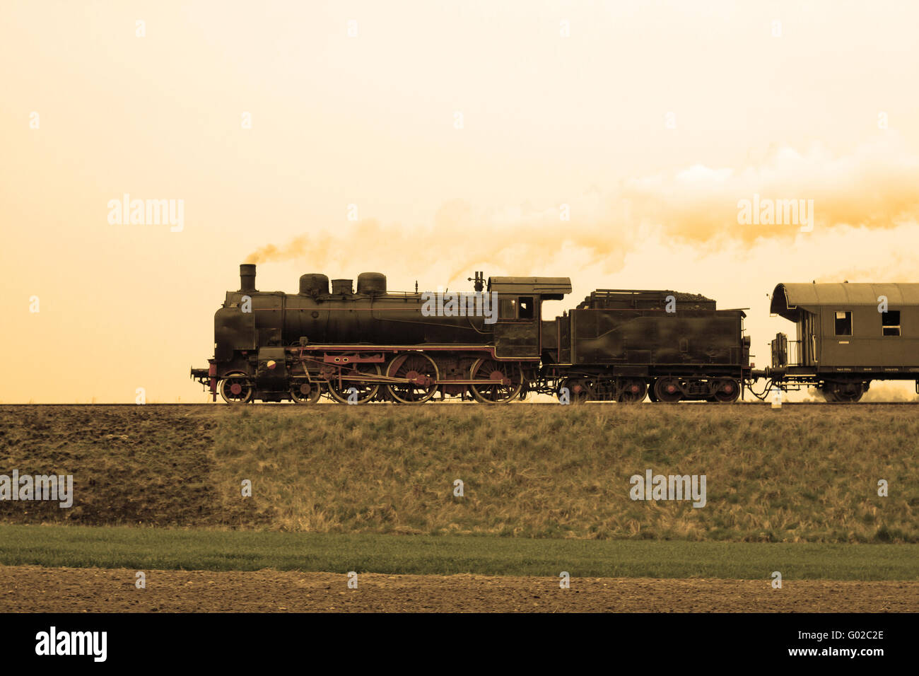 Vintage steam train passing through countryside Stock Photo - Alamy