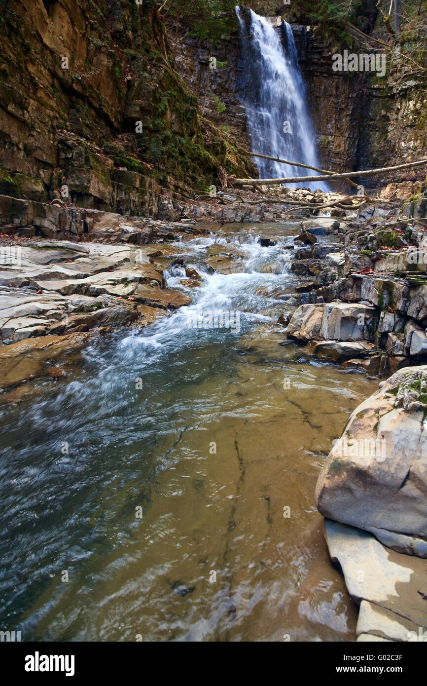 Waterfall and brook in mountain forest ravine Stock Photo - Alamy